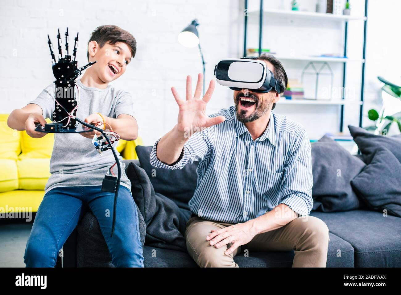 Joyful father and his son testing modern robot Stock Photo - Alamy