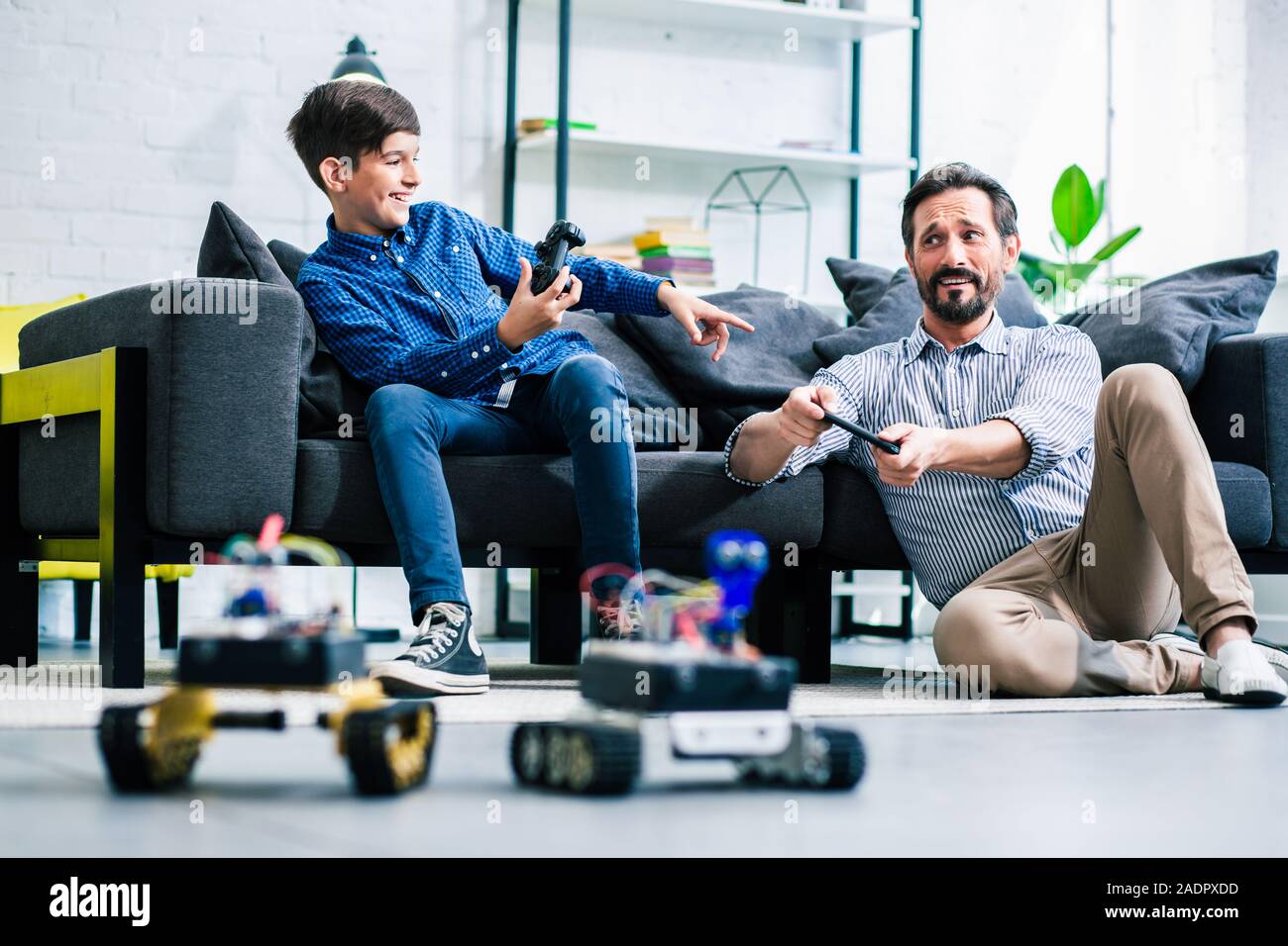 Positive father and son resting together at home Stock Photo - Alamy