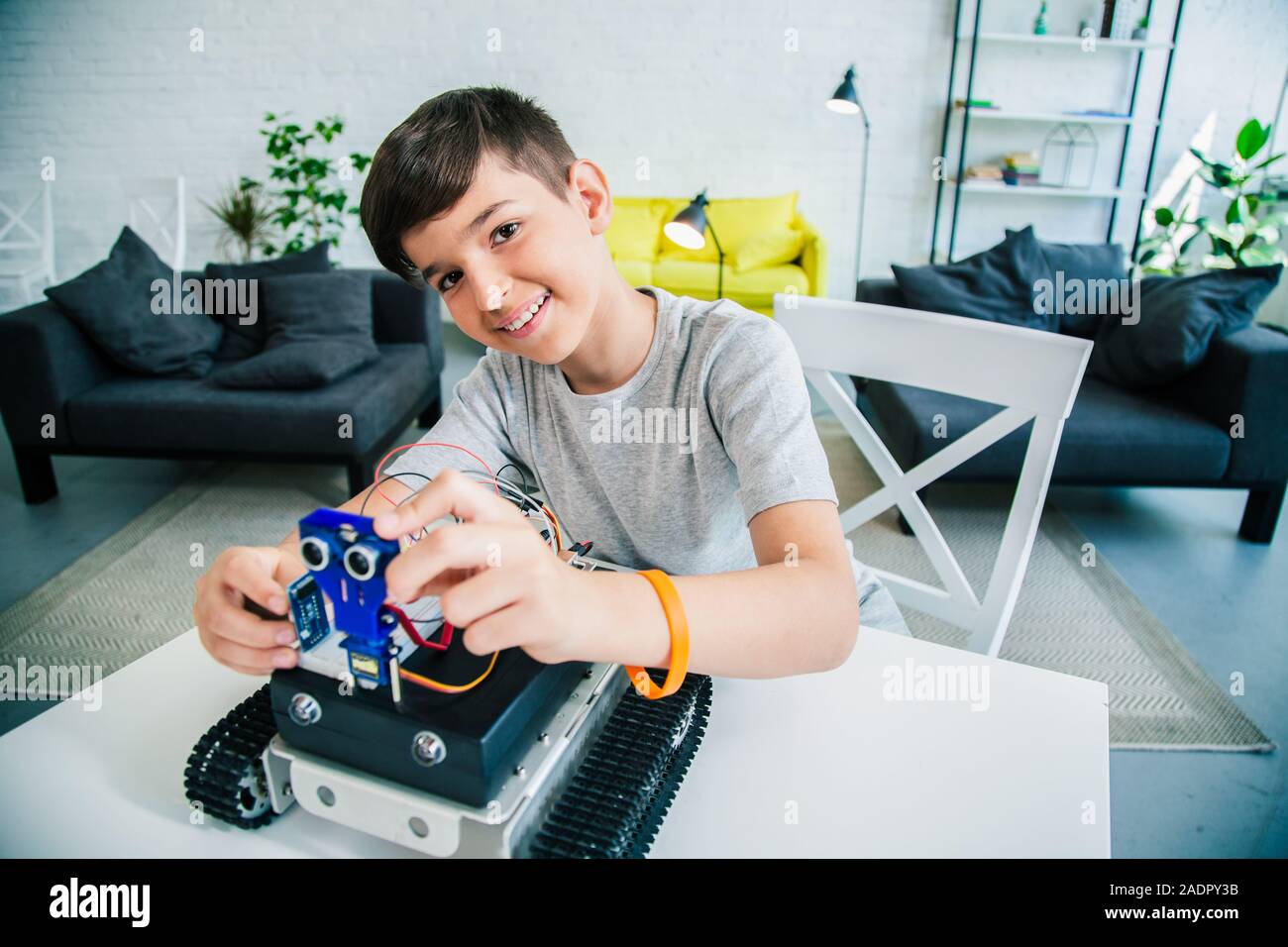 Positive smart schoolboy working on his engineering project Stock Photo ...