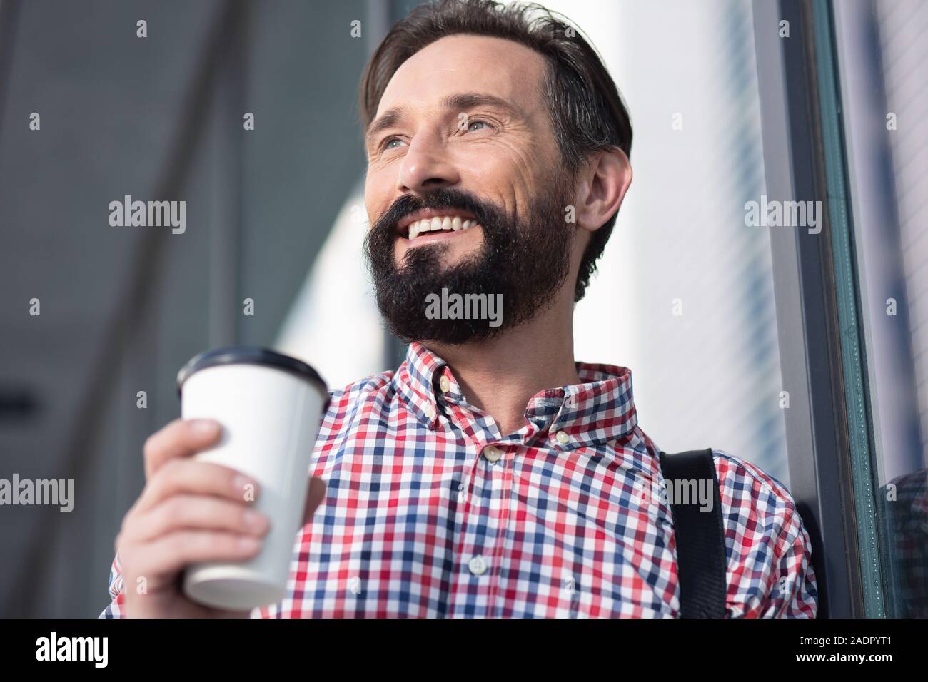 Portrait of a smiling man drinking coffee Stock Photo - Alamy