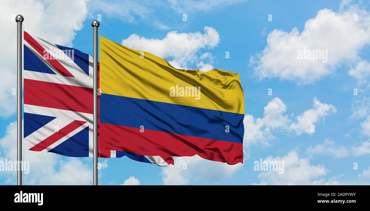 United Kingdom and Colombia flag waving in the wind against white ...