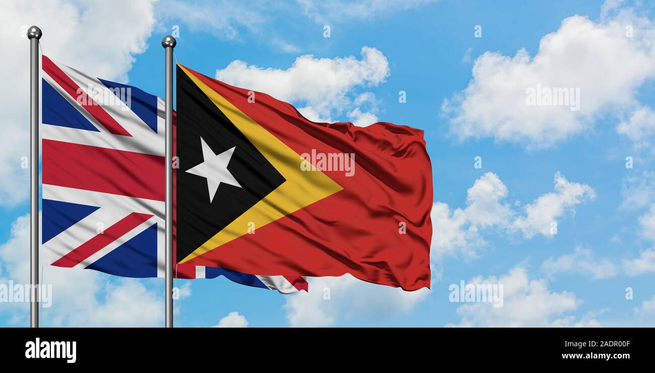 United Kingdom and East Timor flag waving in the wind against white ...