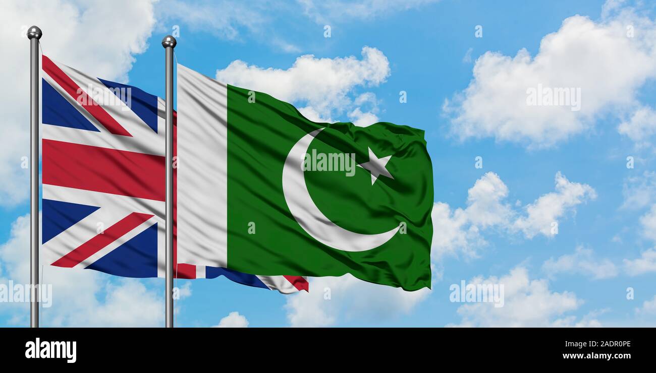 United Kingdom and Pakistan flag waving in the wind against white ...