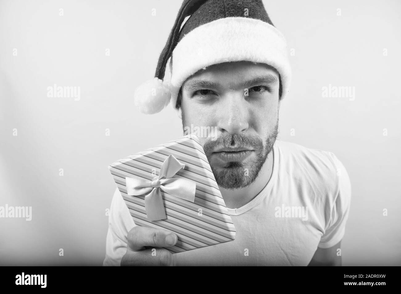 Macho hold xmas box with blue ribbon. Man in santa hat with present on ...