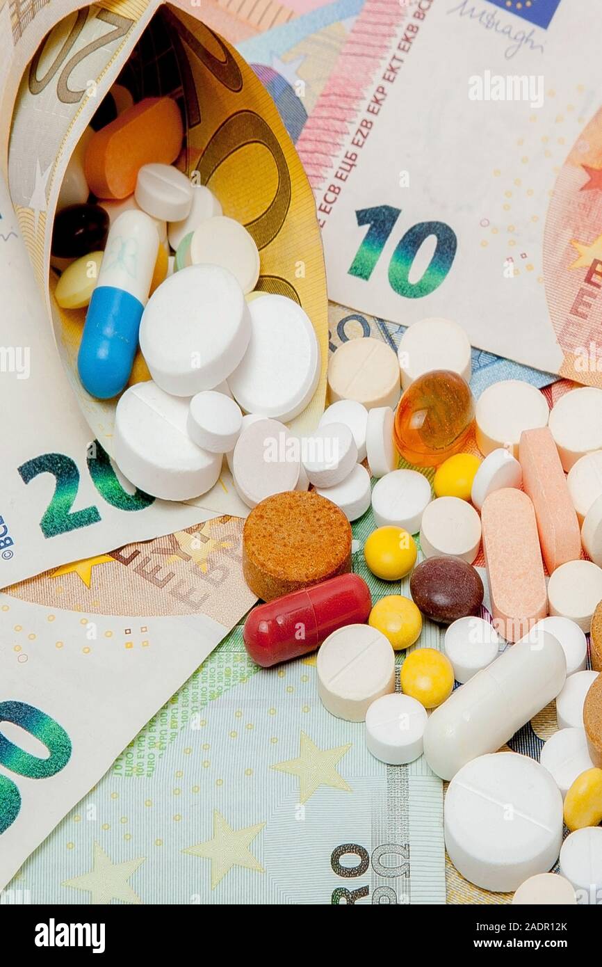 The tablets wrapped in euro with euro banknotes on a pink background ...