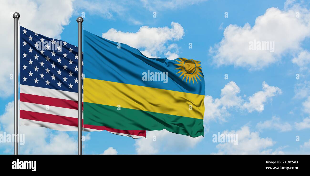 United States and Rwanda flag waving in the wind against white cloudy ...