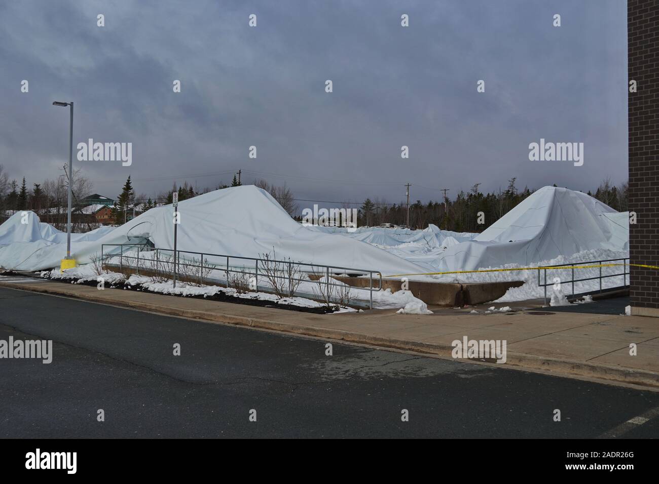 Collapsed inflatable sport dome, after winter snow storm deflated it ...