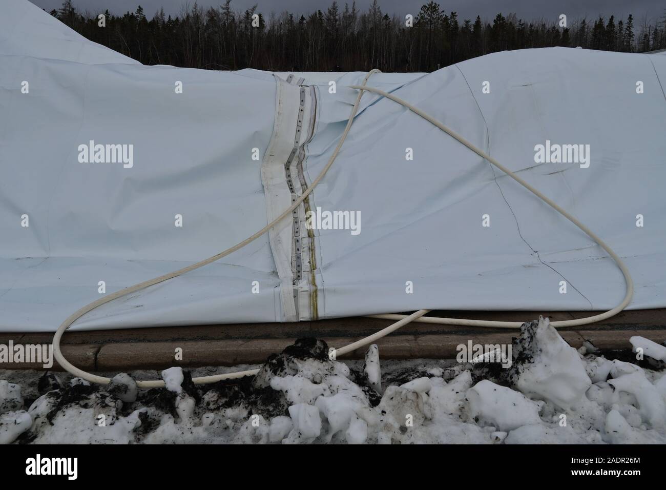 anchor cables of Collapsed inflatable sport dome, after winter snow ...