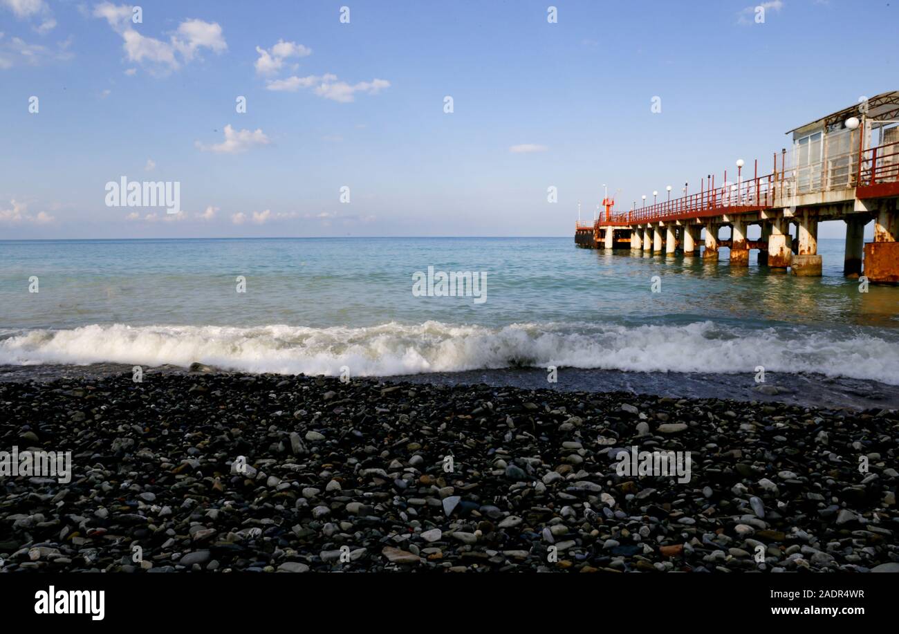 red pier near the beach with stones Stock Photo - Alamy