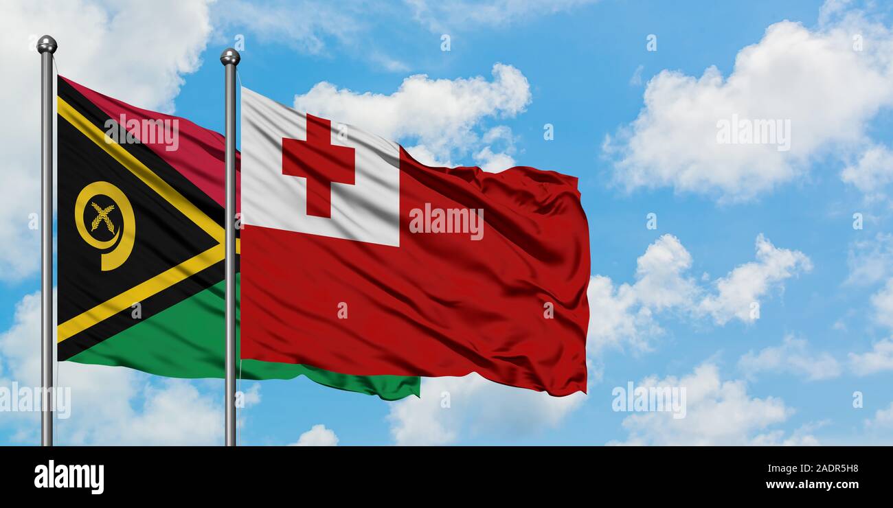 Vanuatu and Tonga flag waving in the wind against white cloudy blue sky ...