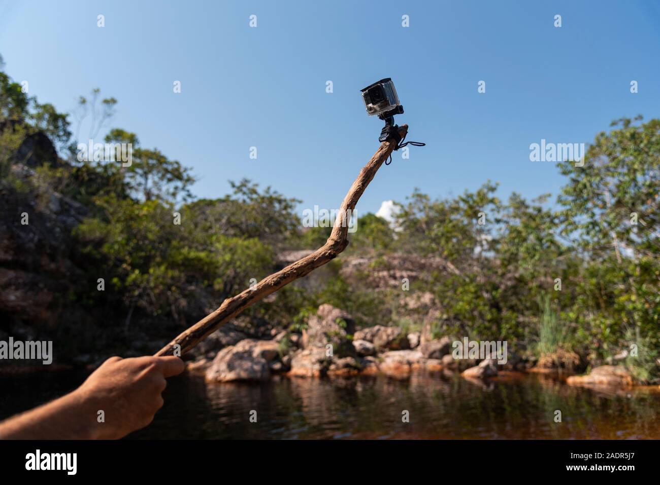 Natural selfie stick made from wooden twig by a river pool, Chapada ...