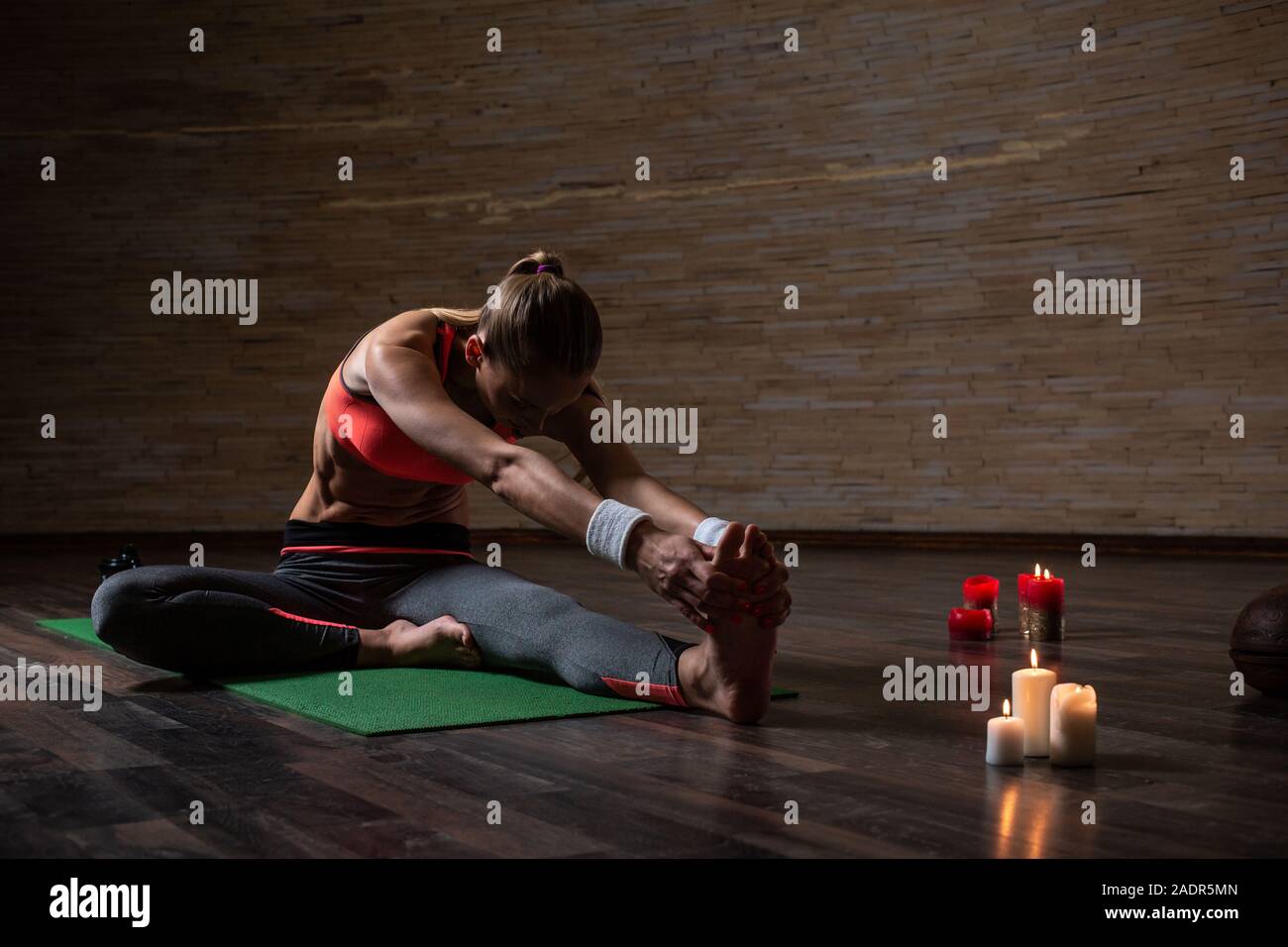 Sporty lady bending her back and touching the toes Stock Photo - Alamy