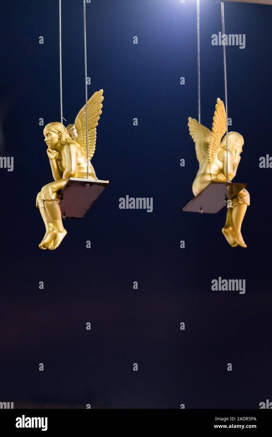 Lunch Break - 35 gilded angels sitting on randomly arranged bars ...