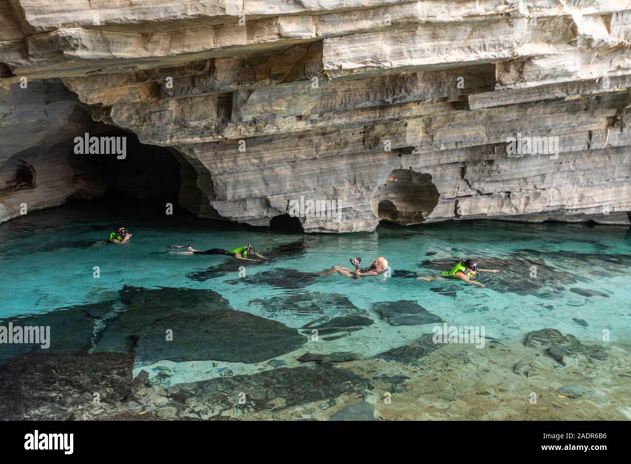 Beautiful view to people snorkeling inside natural blue water river in ...