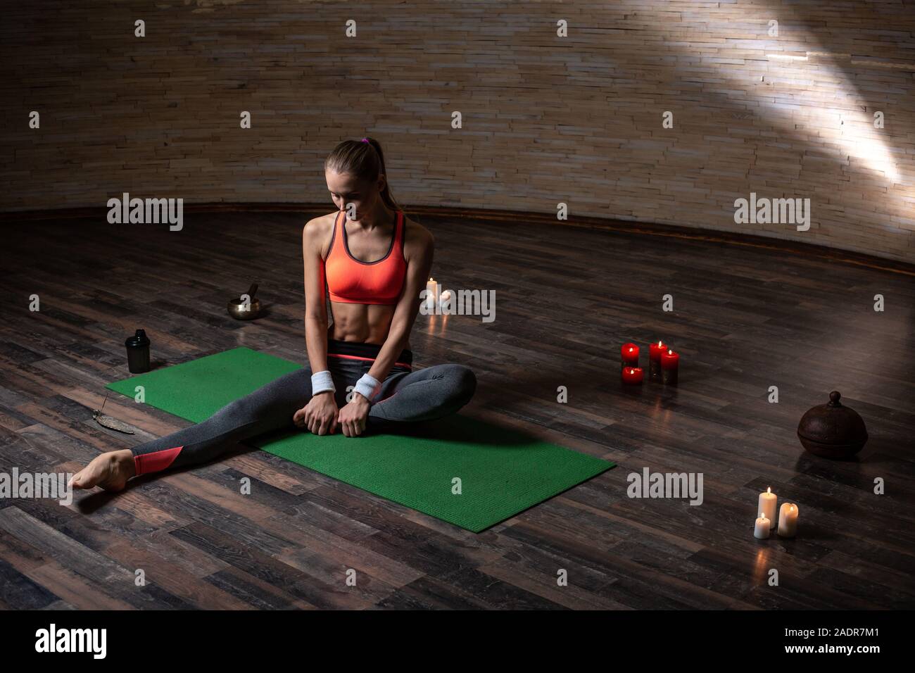 Calm woman stretching her legs while practicing yoga Stock Photo - Alamy