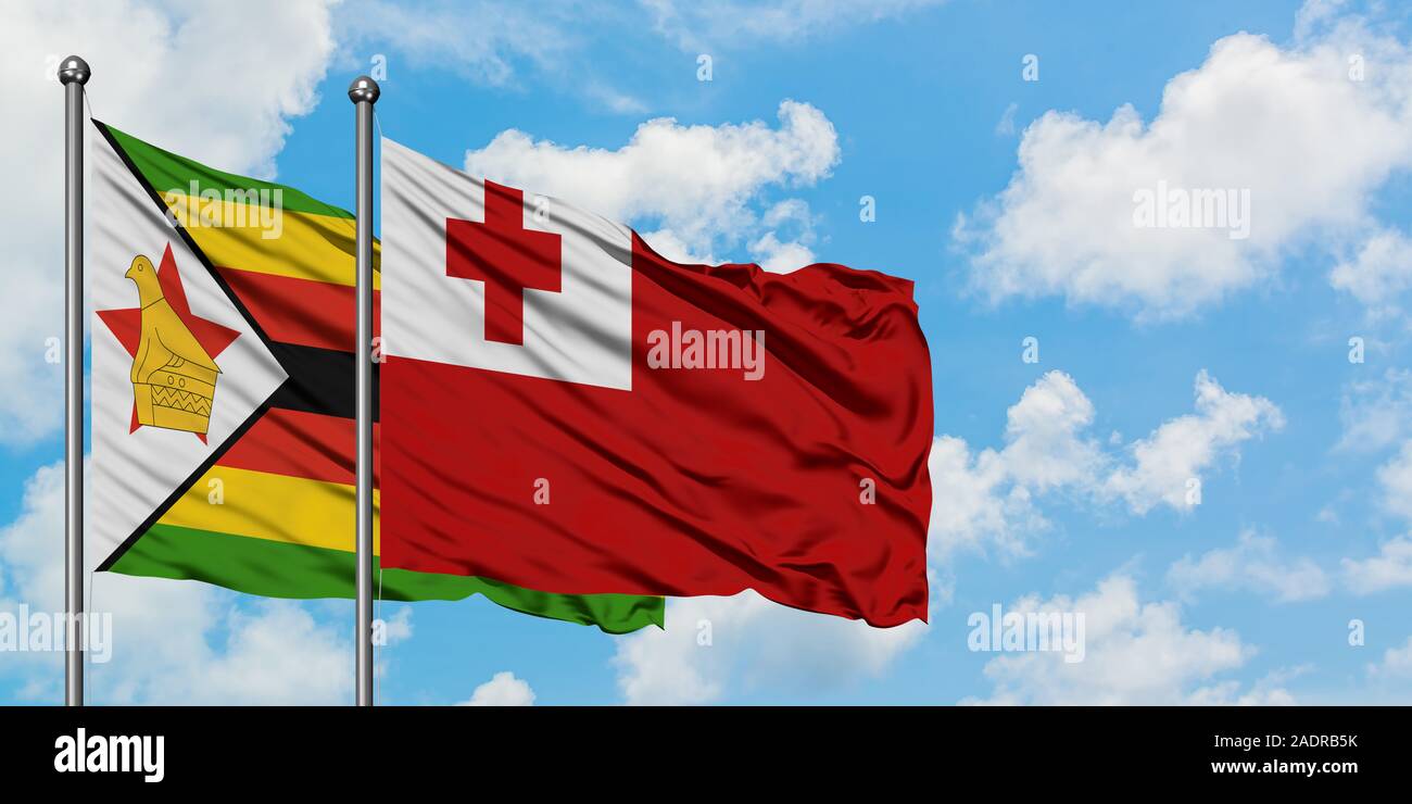 Zimbabwe and Tonga flag waving in the wind against white cloudy blue ...