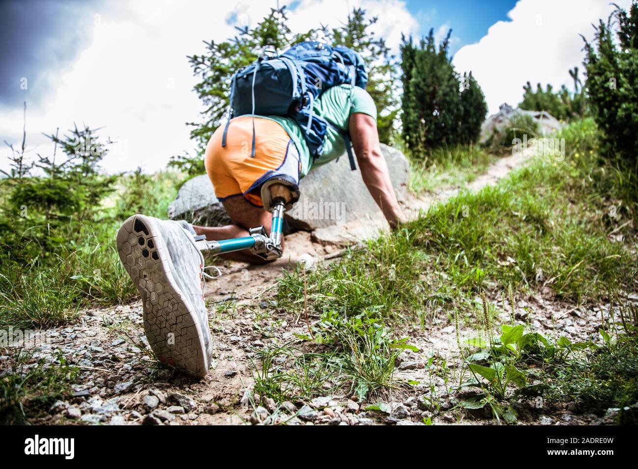 Low angle of a determined active man climbing up Stock Photo - Alamy