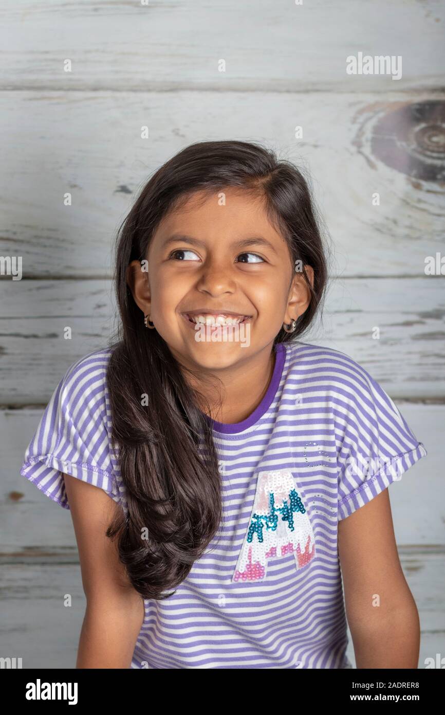 Cute smiling brunette girl with striped shirt Stock Photo - Alamy