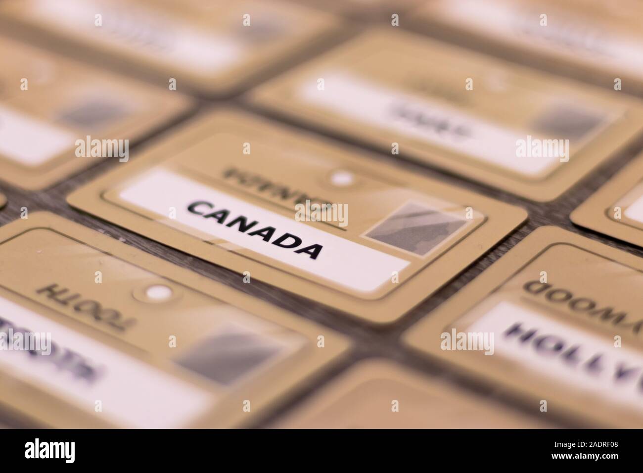 Canada word on a paper card, isolated word with blurred background ...