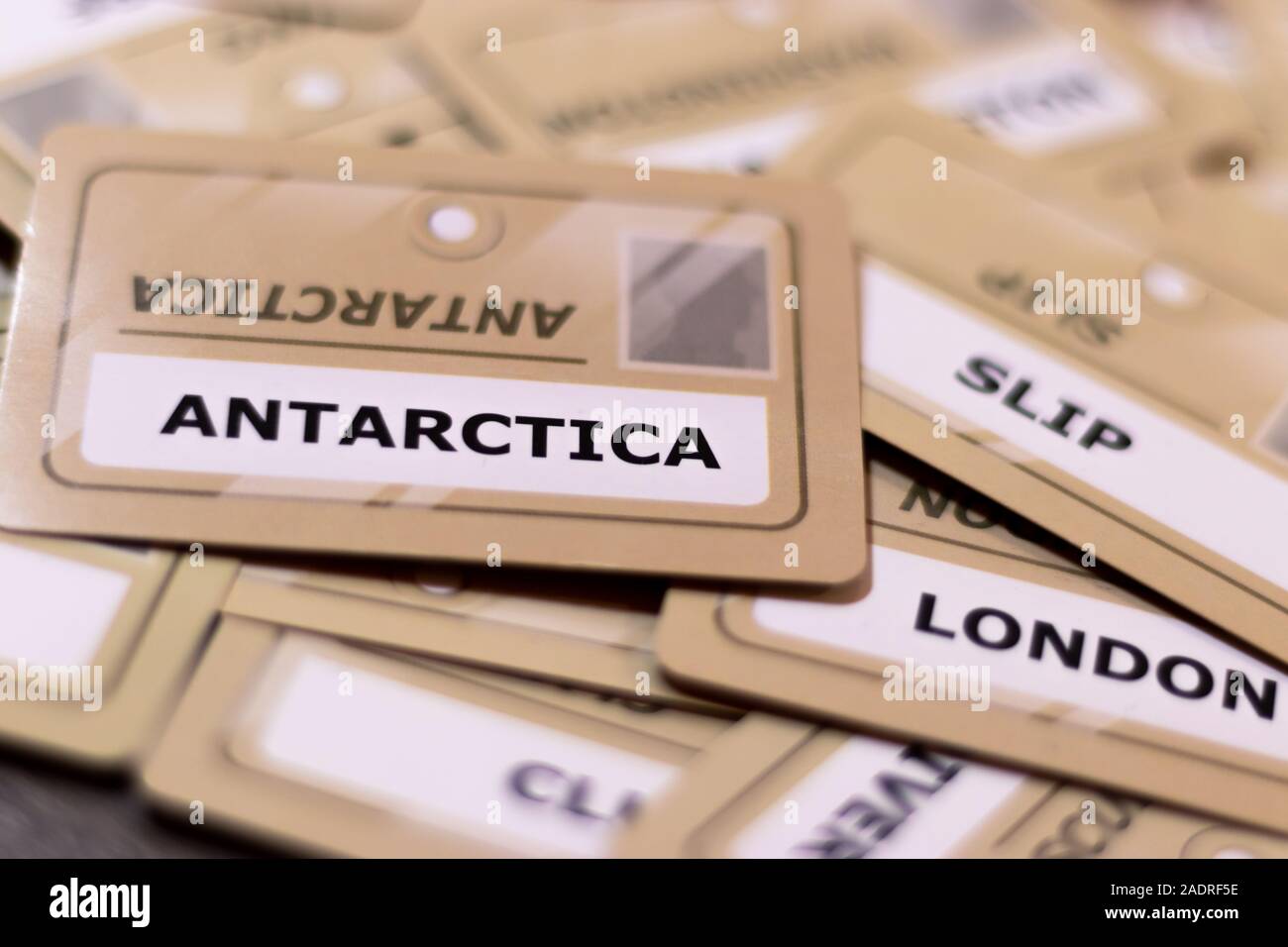 Antarctica word on a yellow card, shallow depth of field. Multiple ...