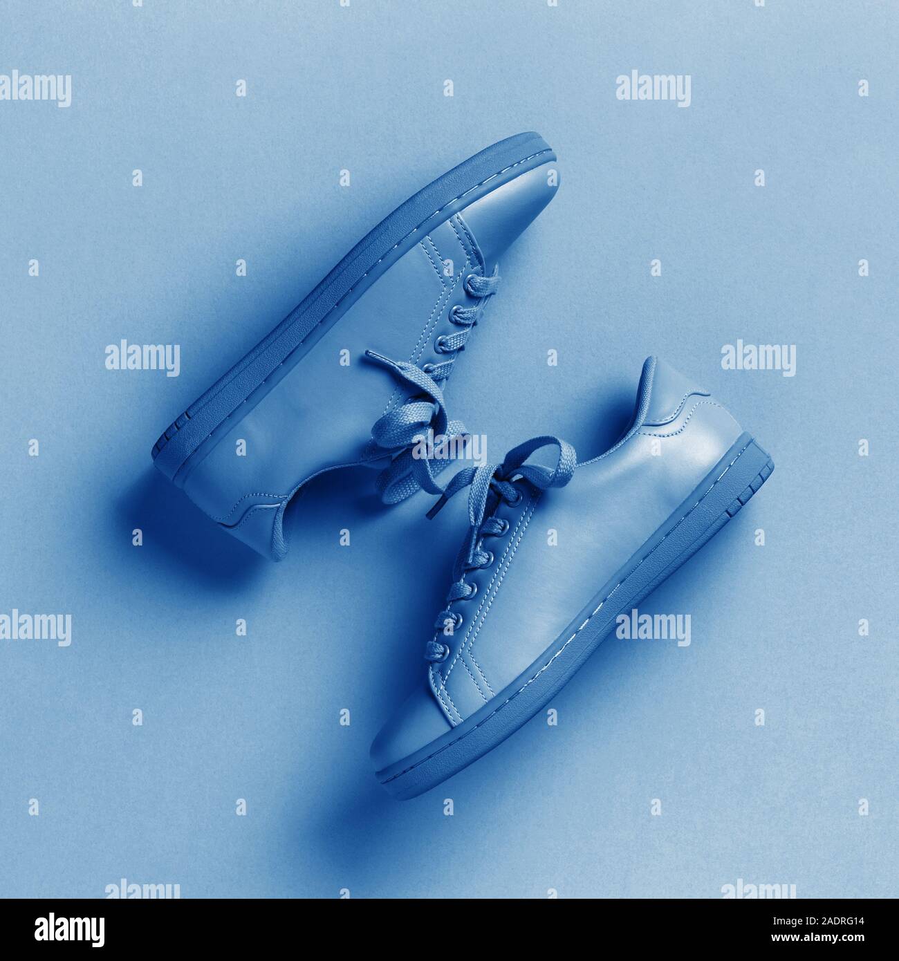 Pair of blue shoes on classic blue background. Trendy color of 2020 ...