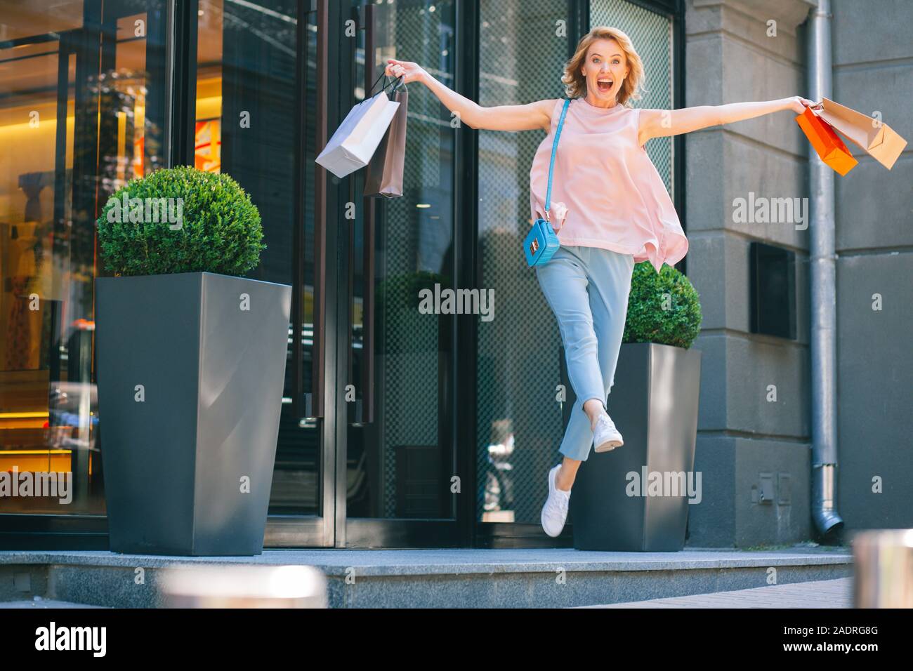 Jumping high on discount day stock photo Stock Photo - Alamy