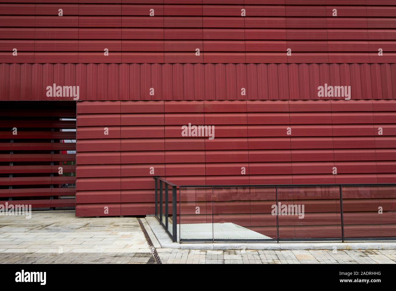 Red metal facade design and glass railing for modern building Stock ...
