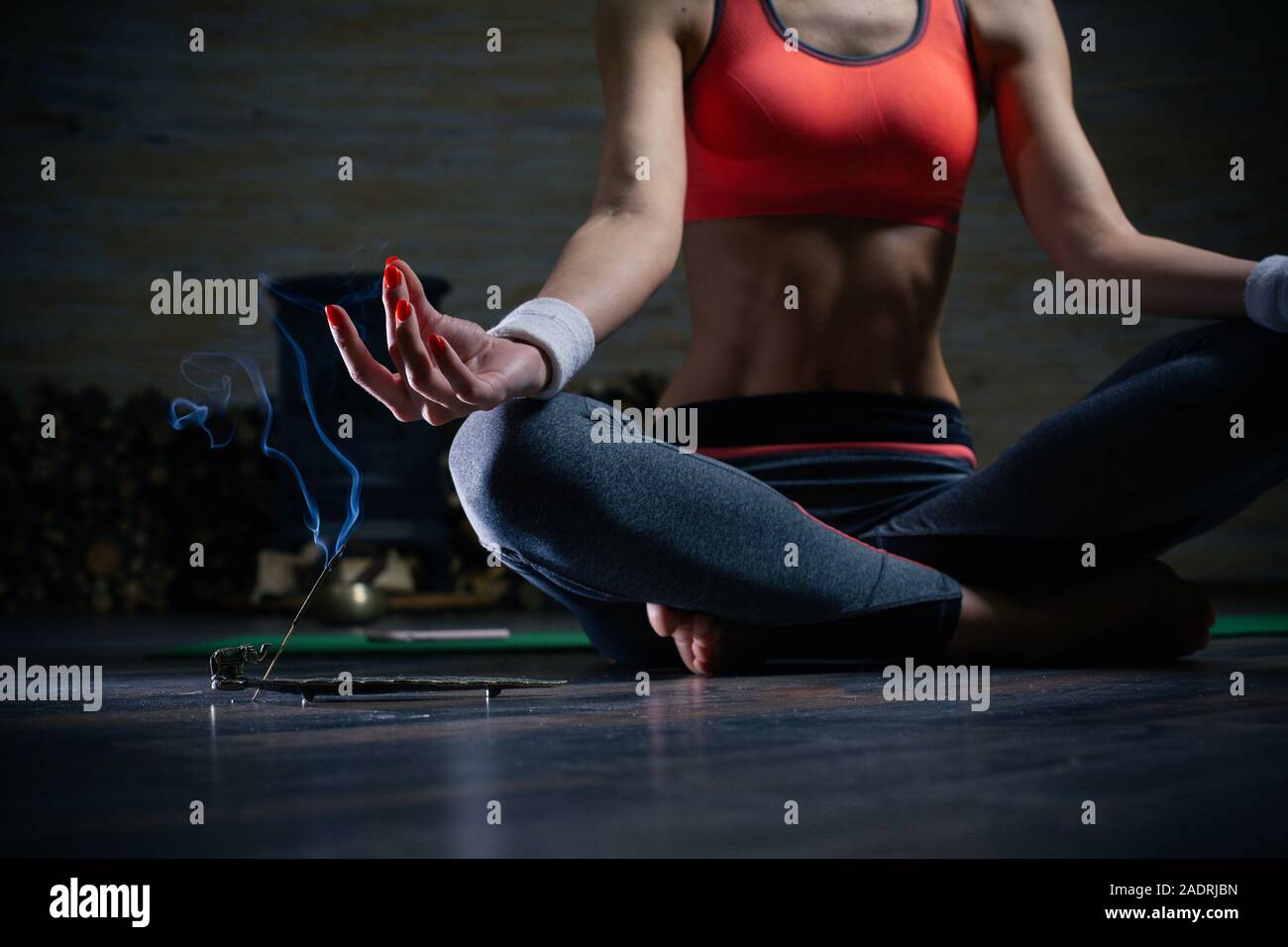 Slim woman with red nails having legs crossed and meditating Stock ...