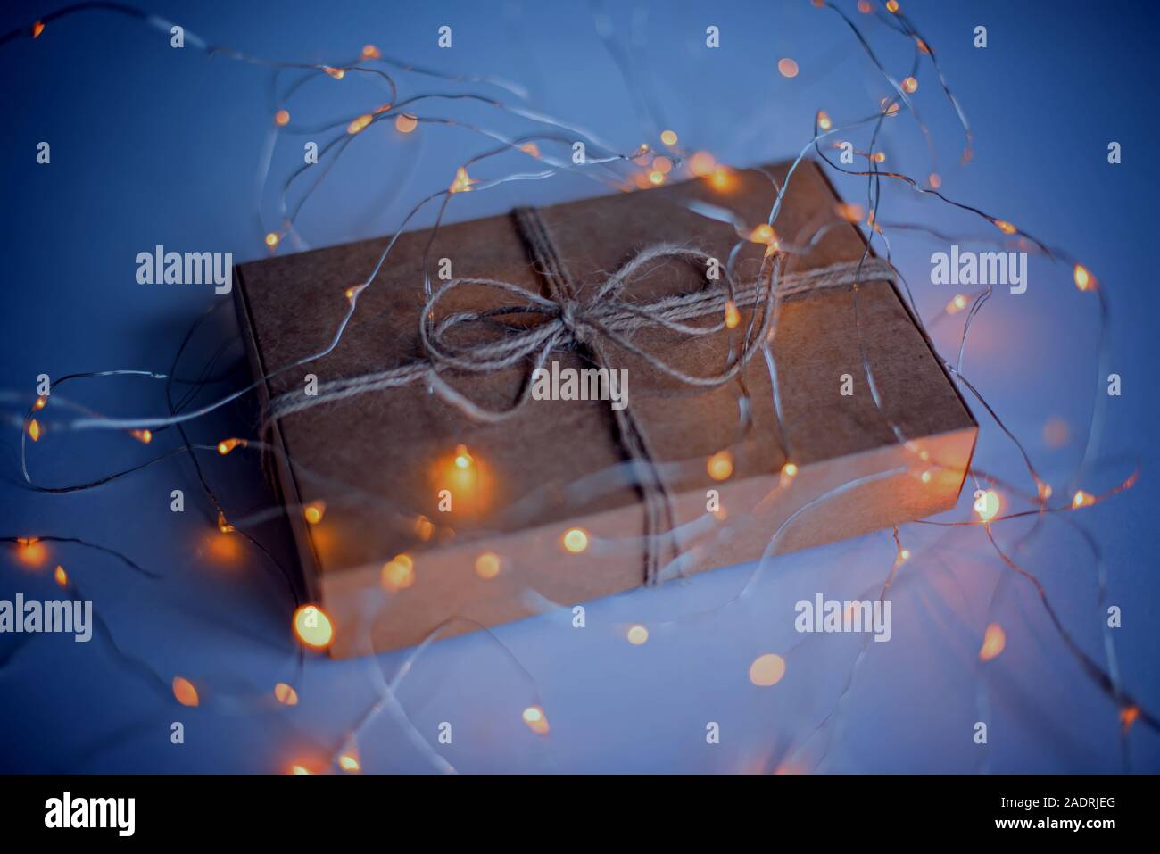 Color of the year 2020: Blue. Gift box of craft cardboard in a luminous ...