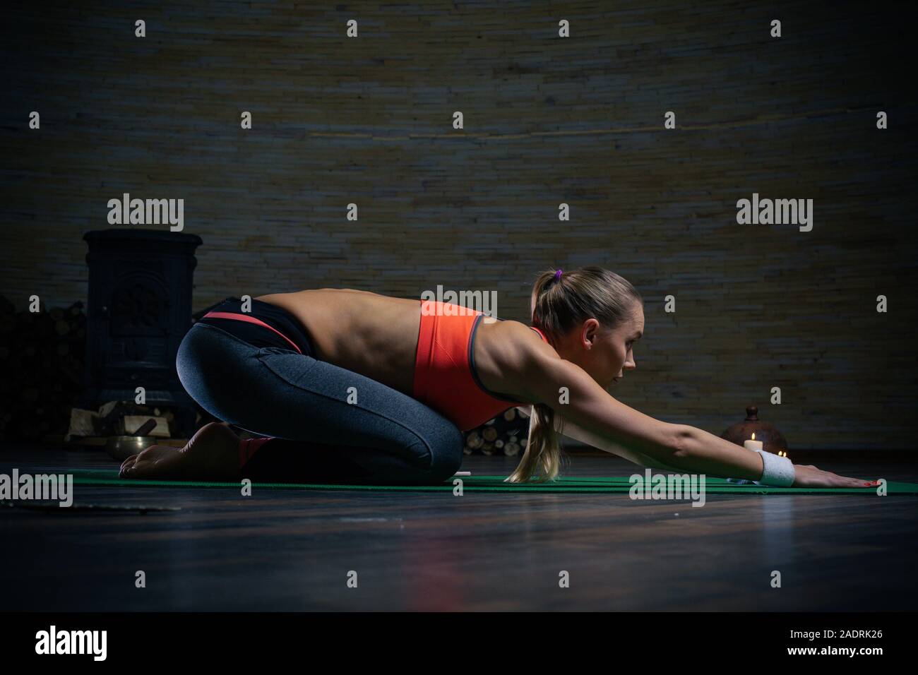 Slim sporty lady bending her back and putting hands on the floor Stock ...