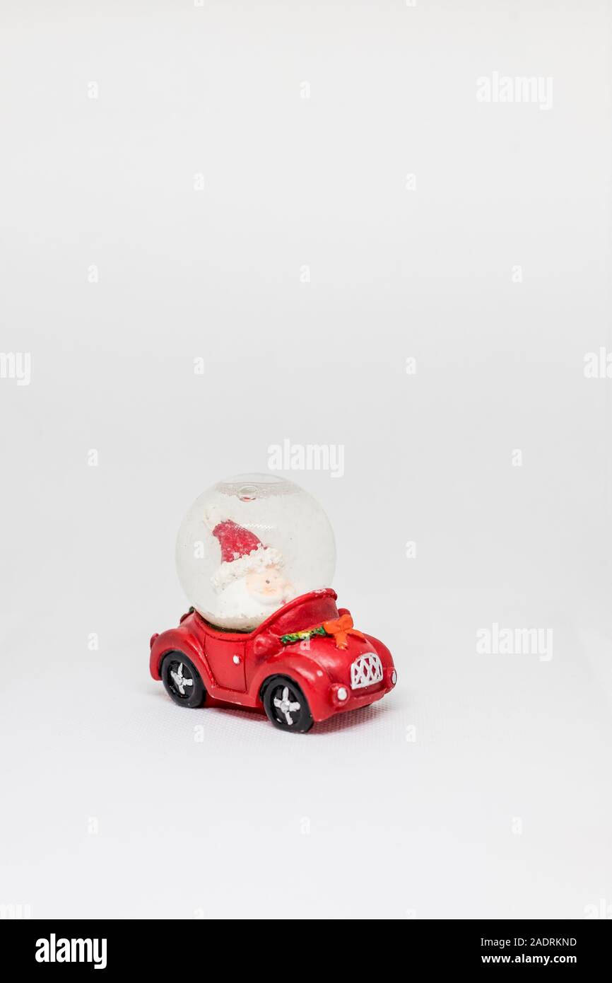 Concept red car with santa isolated on white background. Snow globe is ...