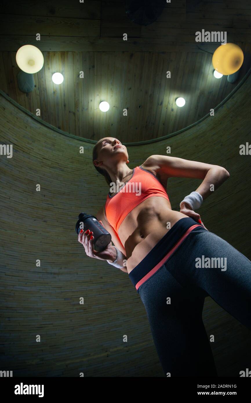 Bottom view of the confident sporty lady with sporty bottle Stock Photo ...