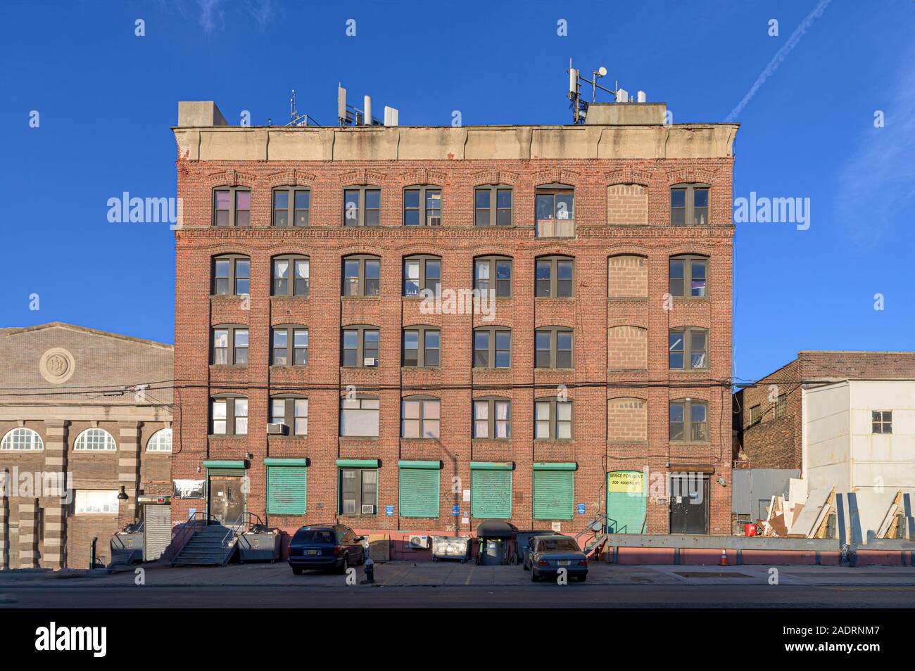 An old-fashioned brickwall factory building against a blue sky on a ...