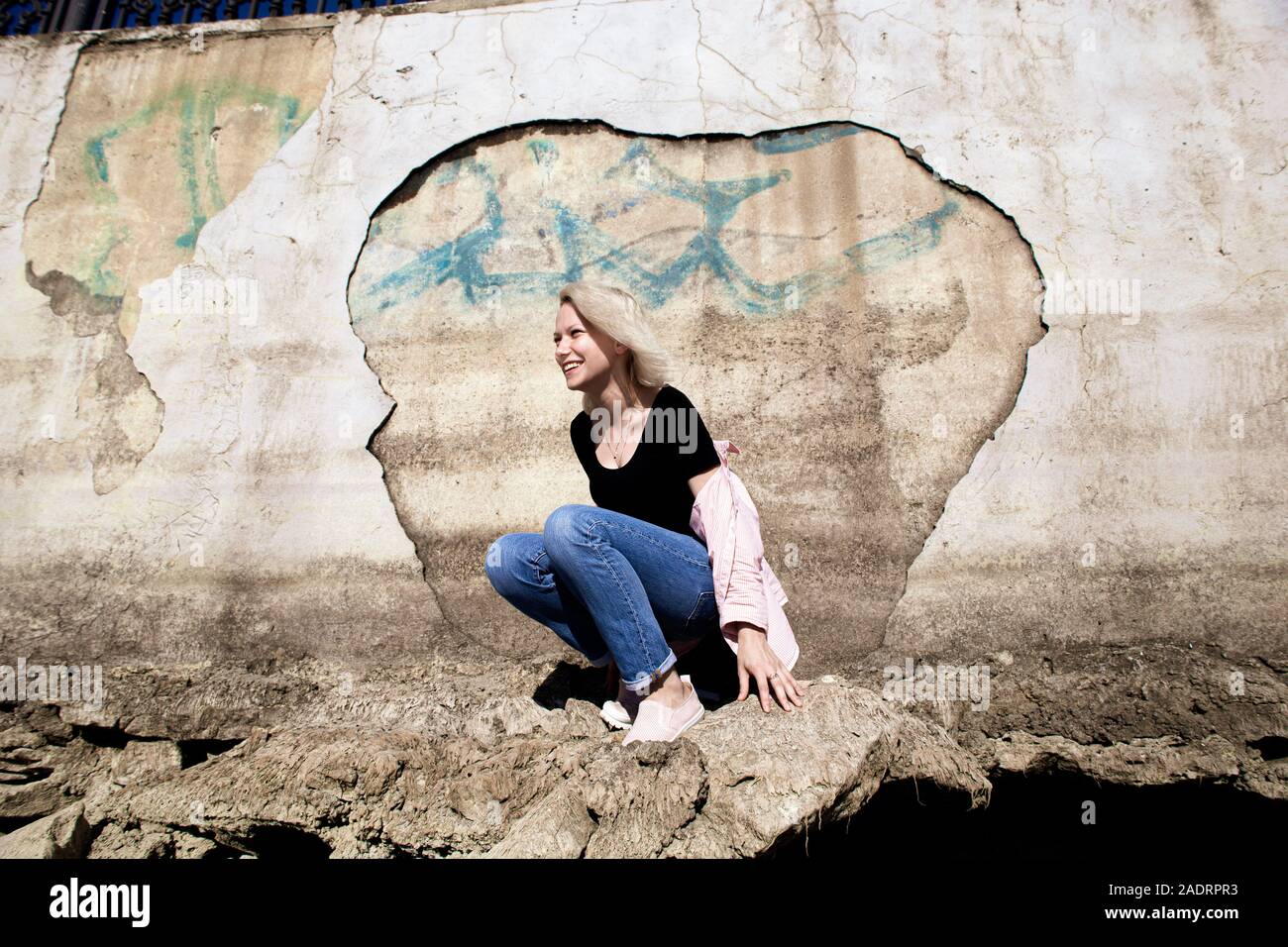 girl near the shattered wall Stock Photo - Alamy