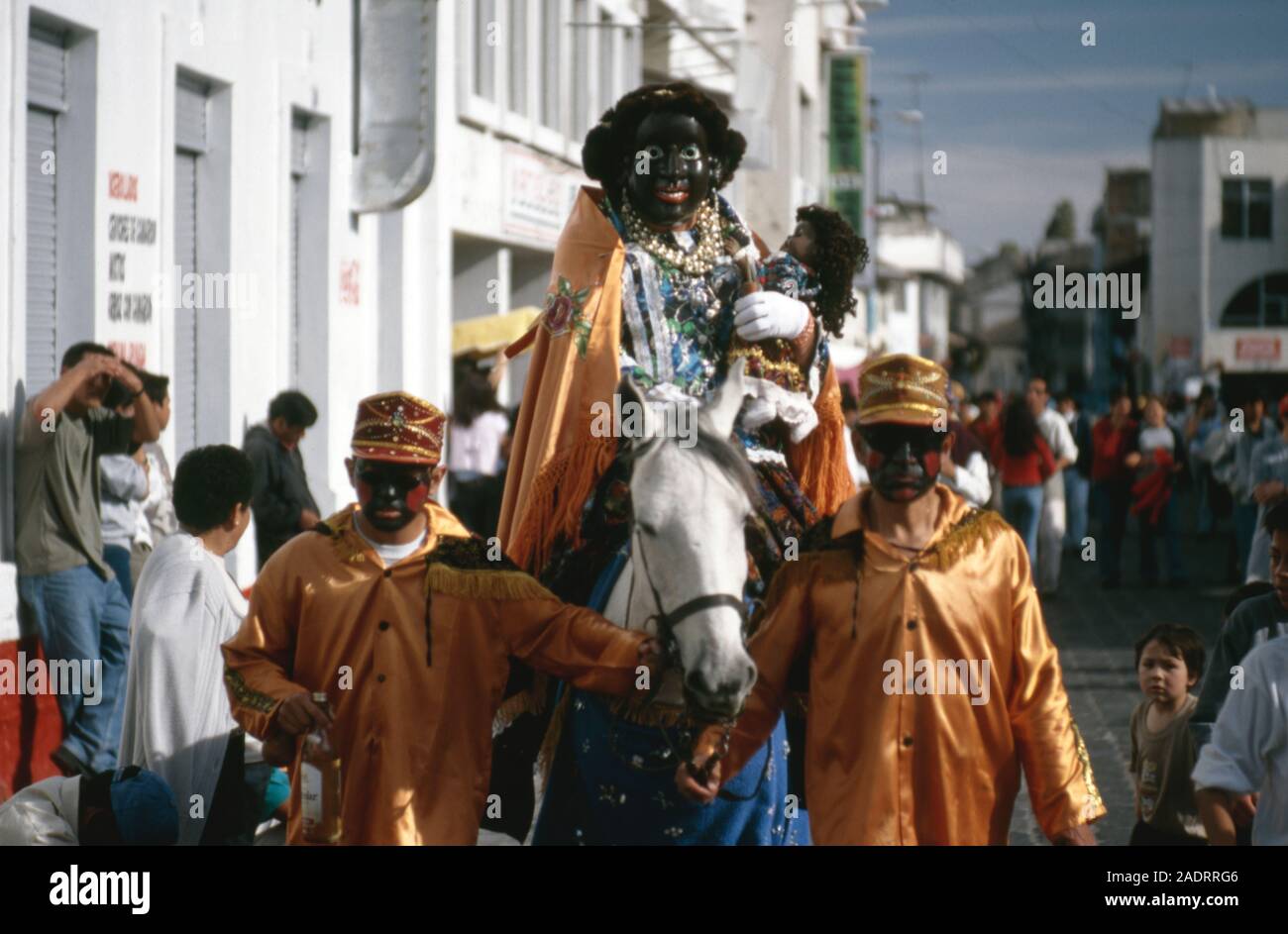 Mamá Negra holding her "baby" at the annual pagan/Catholic "Fiesta de ...