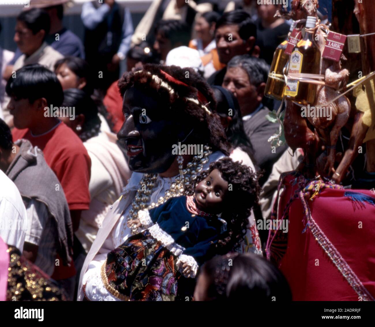 Mamá Negra holding her "baby" at the annual pagan/Catholic "Fiesta de ...