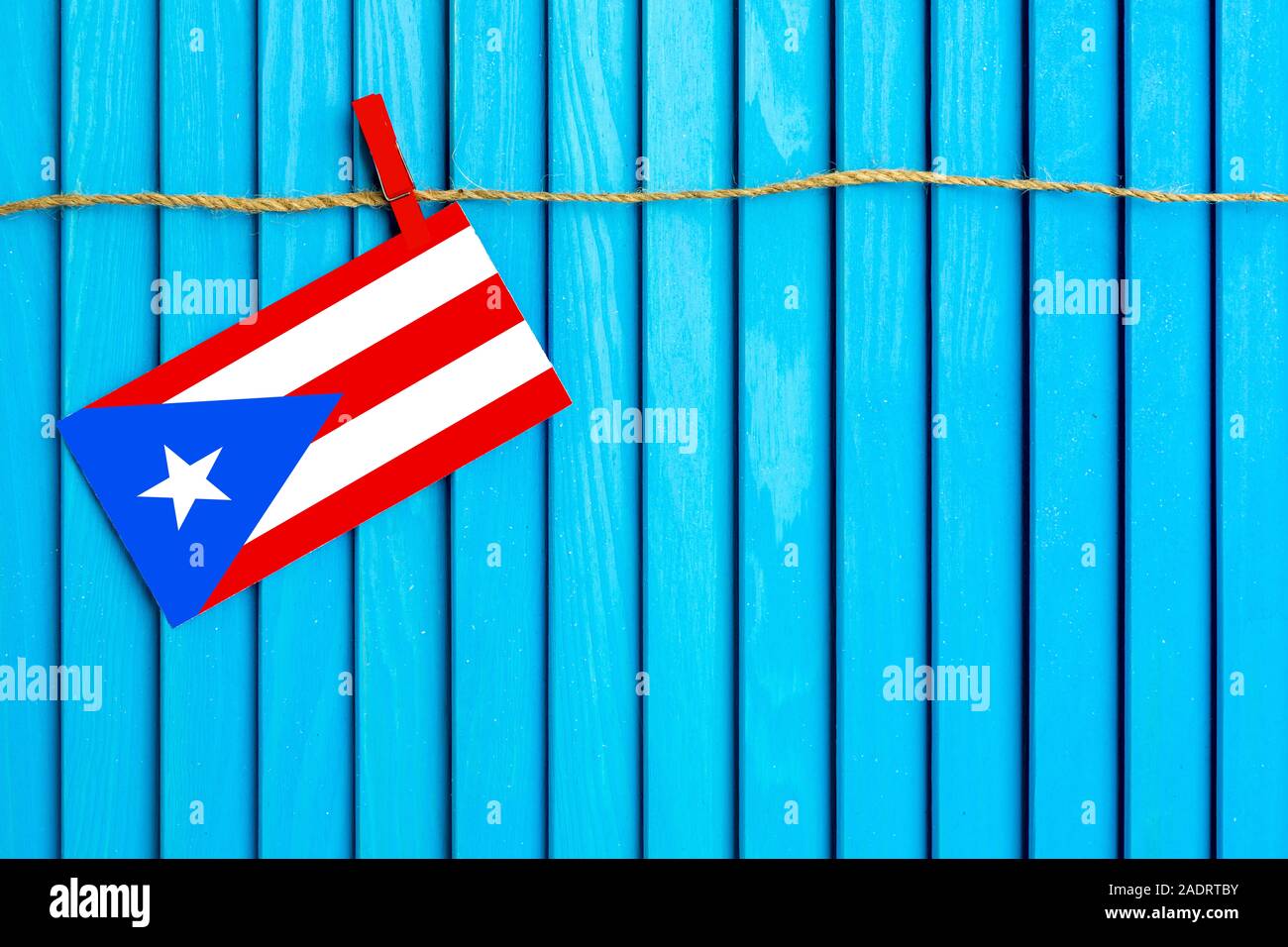 Flag of Puerto Rico hanging on clothesline attached with wooden ...