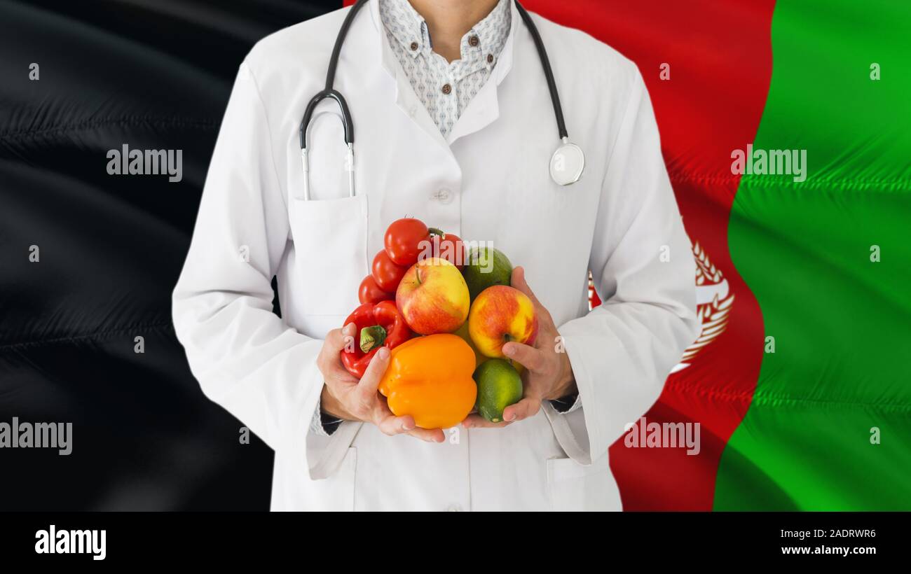 Afghan Doctor is holding fruits and vegetables in hands with ...