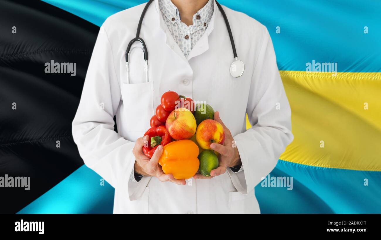 Bahamian Doctor is holding fruits and vegetables in hands with Bahamas ...
