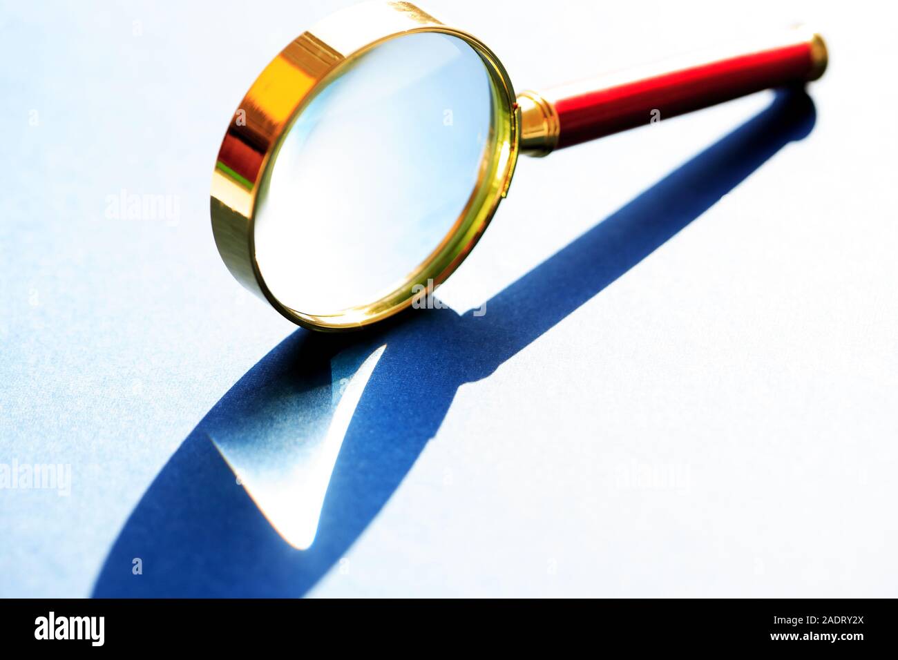 Nice retro magnifying glass under sunlight on gray background Stock ...