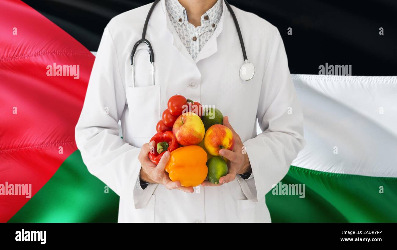 Doctor is holding fruits and vegetables in hands with Palestine flag ...