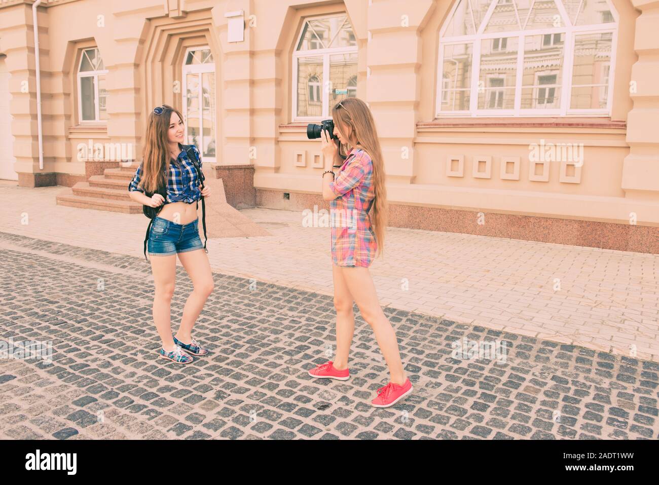 beautiful girl on the tour photographing his girlfriend Stock Photo - Alamy