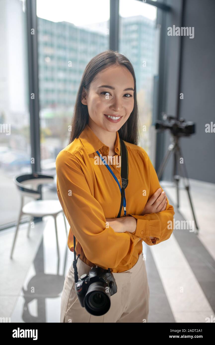 Dark-haired young cute reporter standing in the studio Stock Photo - Alamy