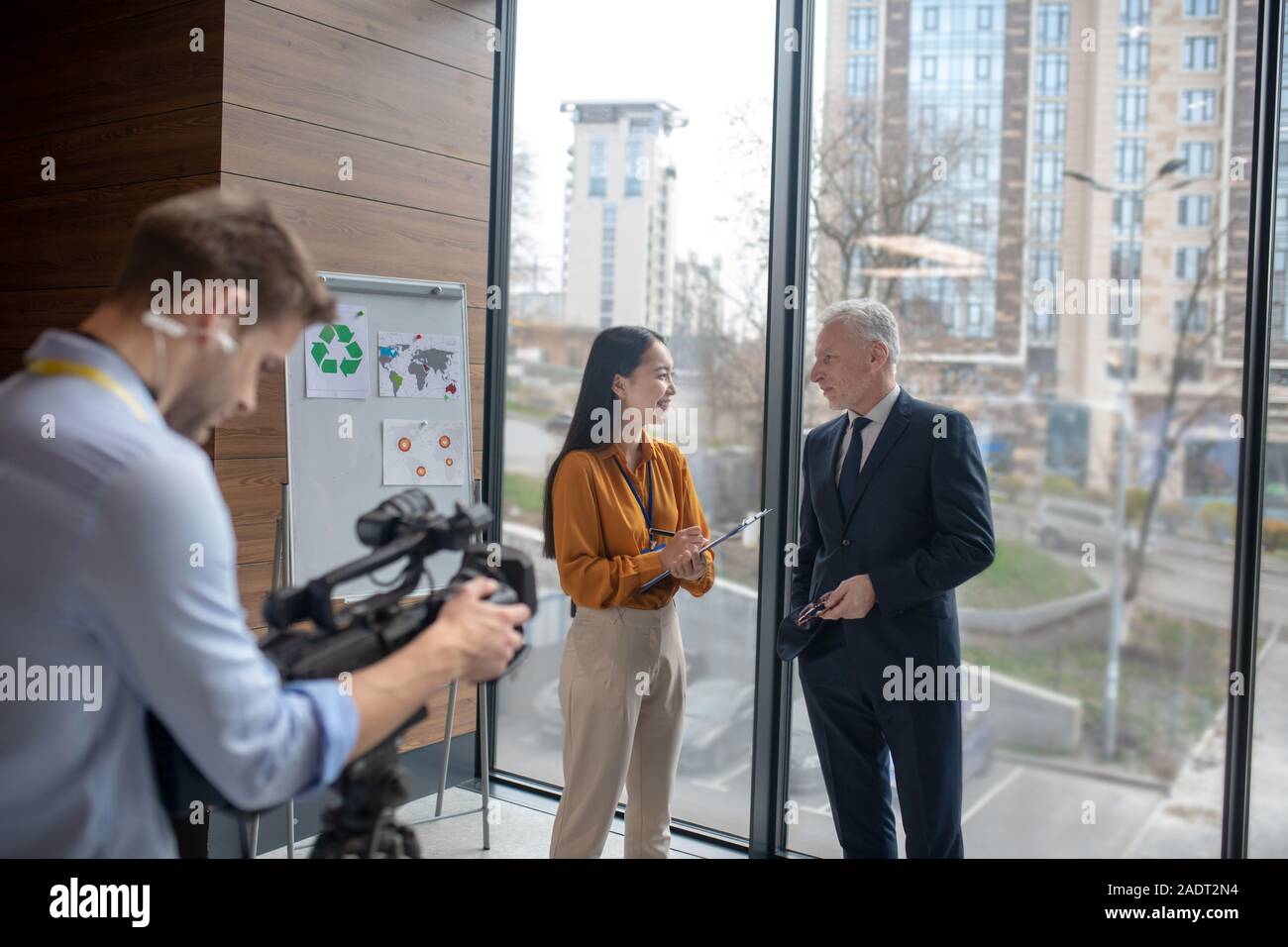 Young asian reporter having a conversation with a grey-haired man Stock ...