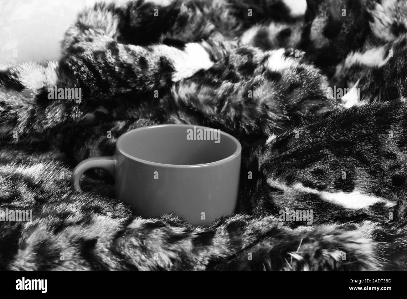 Red orange tea or coffee cup or ceramic mug for drink on spotted fluffy ...