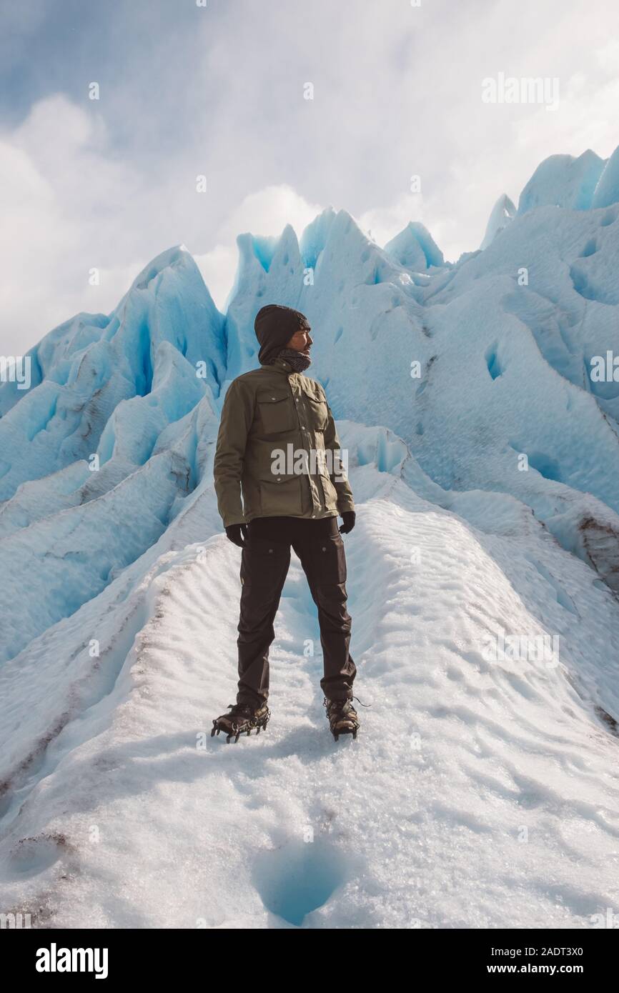 Male explorer standing on glacier Stock Photo - Alamy