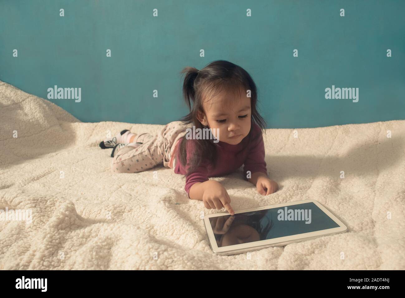 little girl playing tablet Stock Photo - Alamy