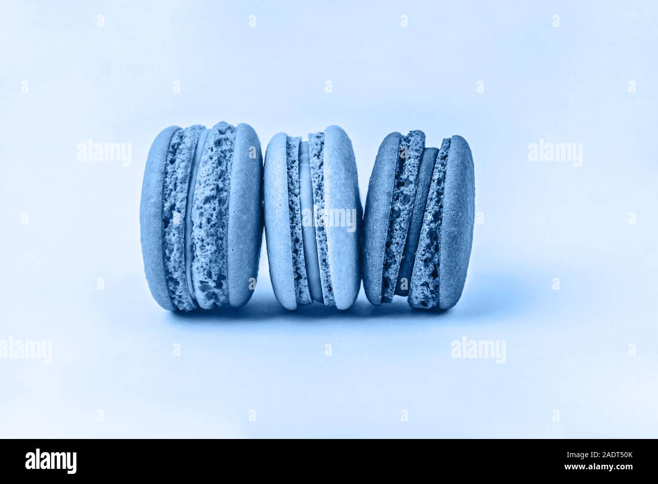 Assorted colorful macaroons toned blue background with copy space Stock ...