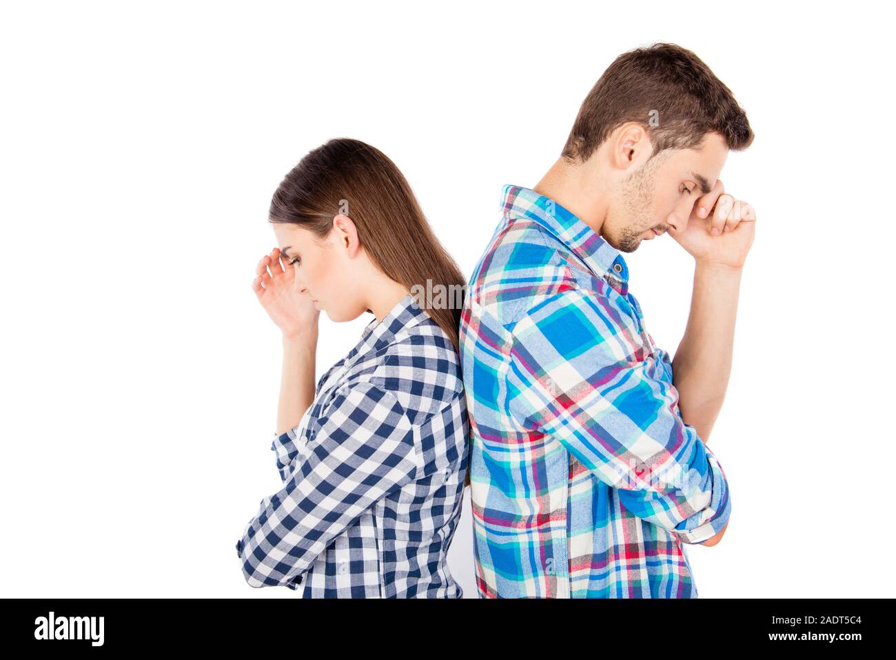 Couple standing back to back Stock Photo - Alamy
