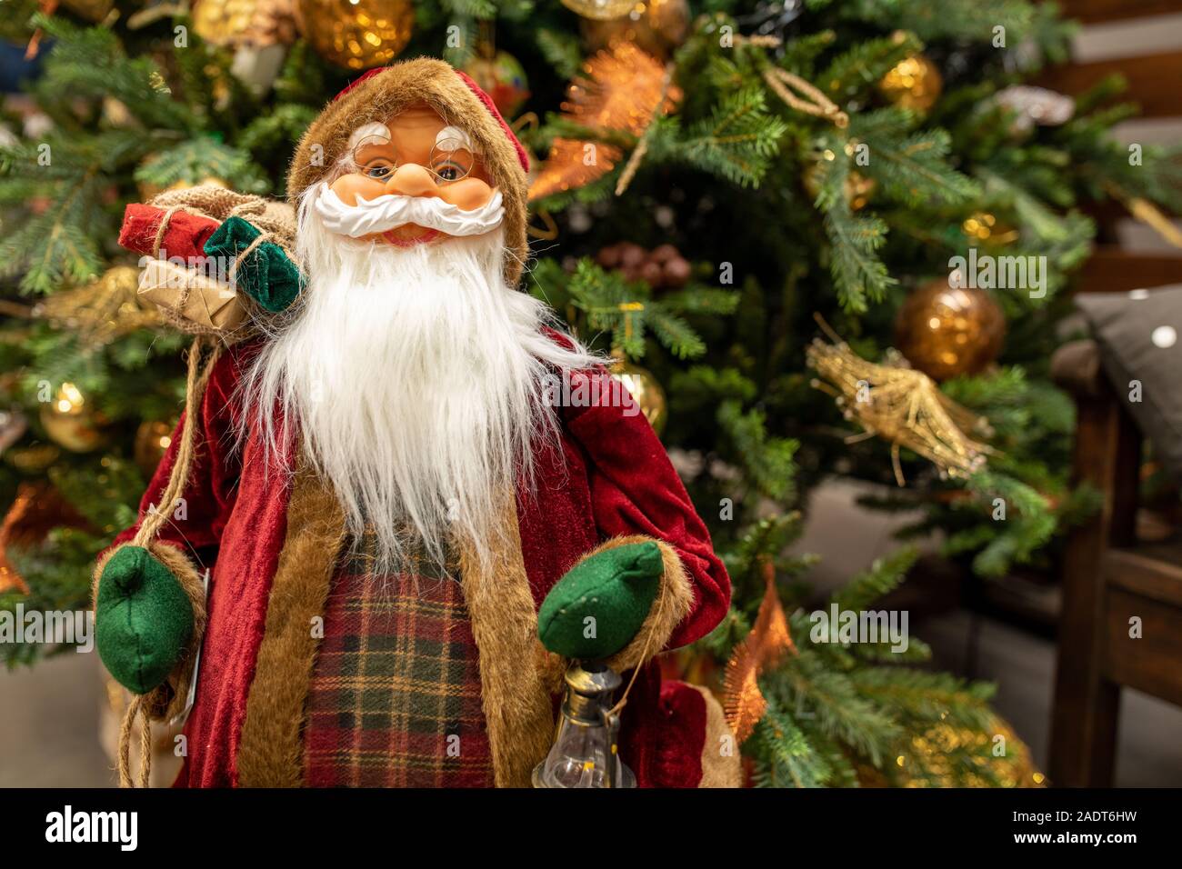 Cute stuffed toy Santa Claus giving a Christmas present. Stuffed toy ...